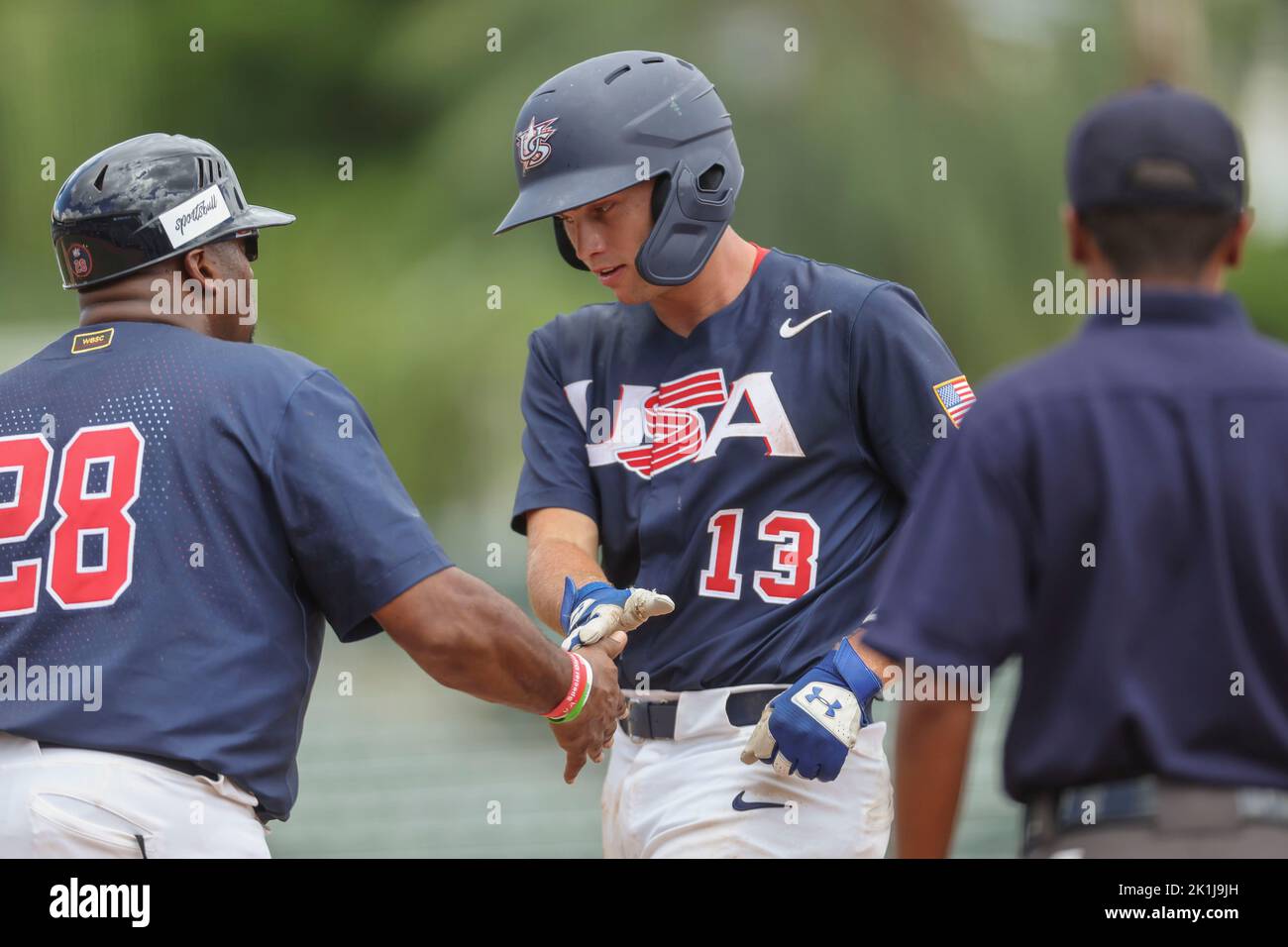 Sarasota, FL. USA; Team USA first base coach Roberto Vaz (28) fist ...