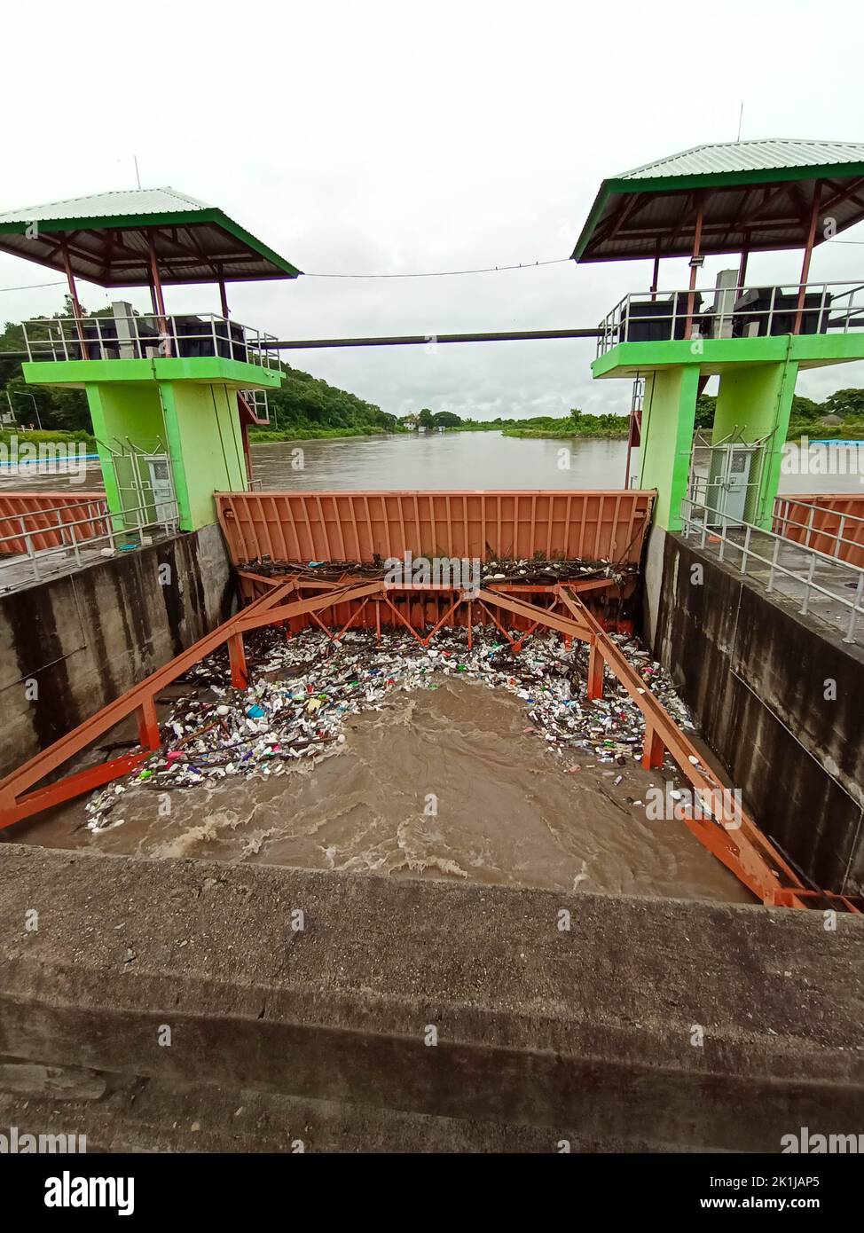 Aerial view of turbid brown forest water released by concrete dam ...