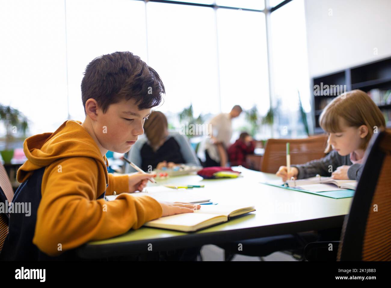 Boys studying in library hi-res stock photography and images - Alamy