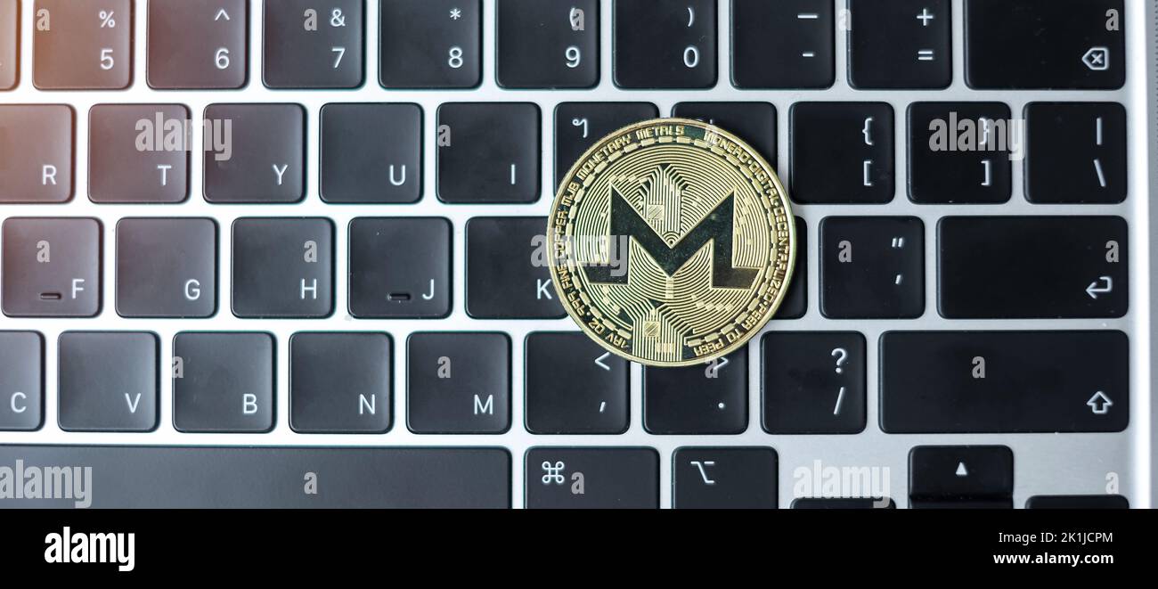 golden Cryptocurrency on keyboard laptop, Monero coin. Crypto is ...
