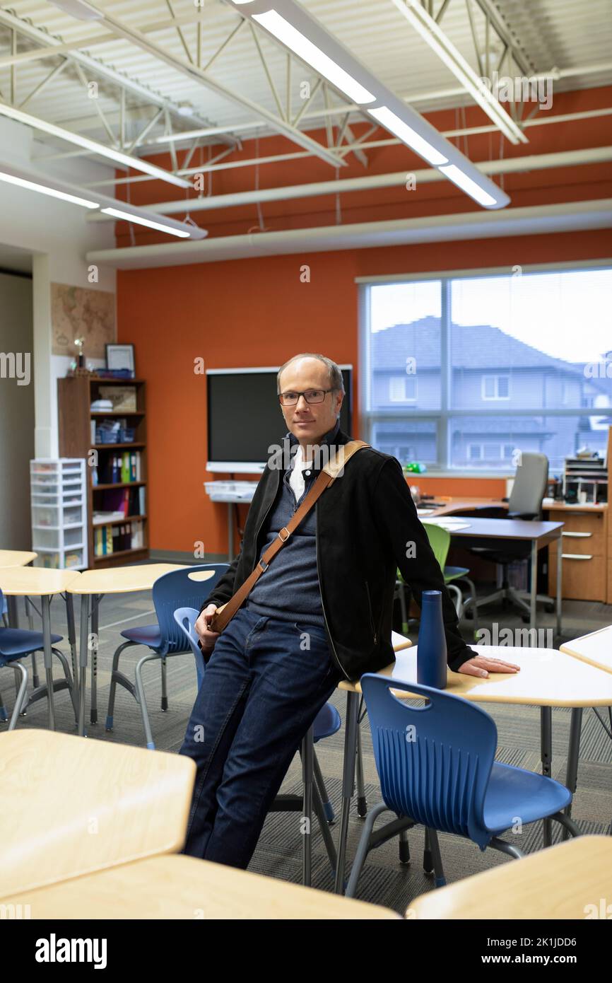 Portrait confident male junior high teacher in classroom Stock Photo ...