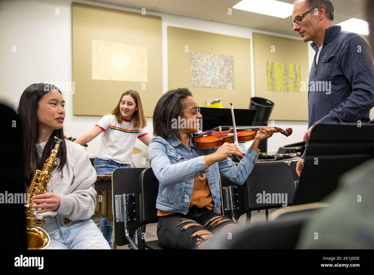 Students playing musical instruments hi-res stock photography and ...