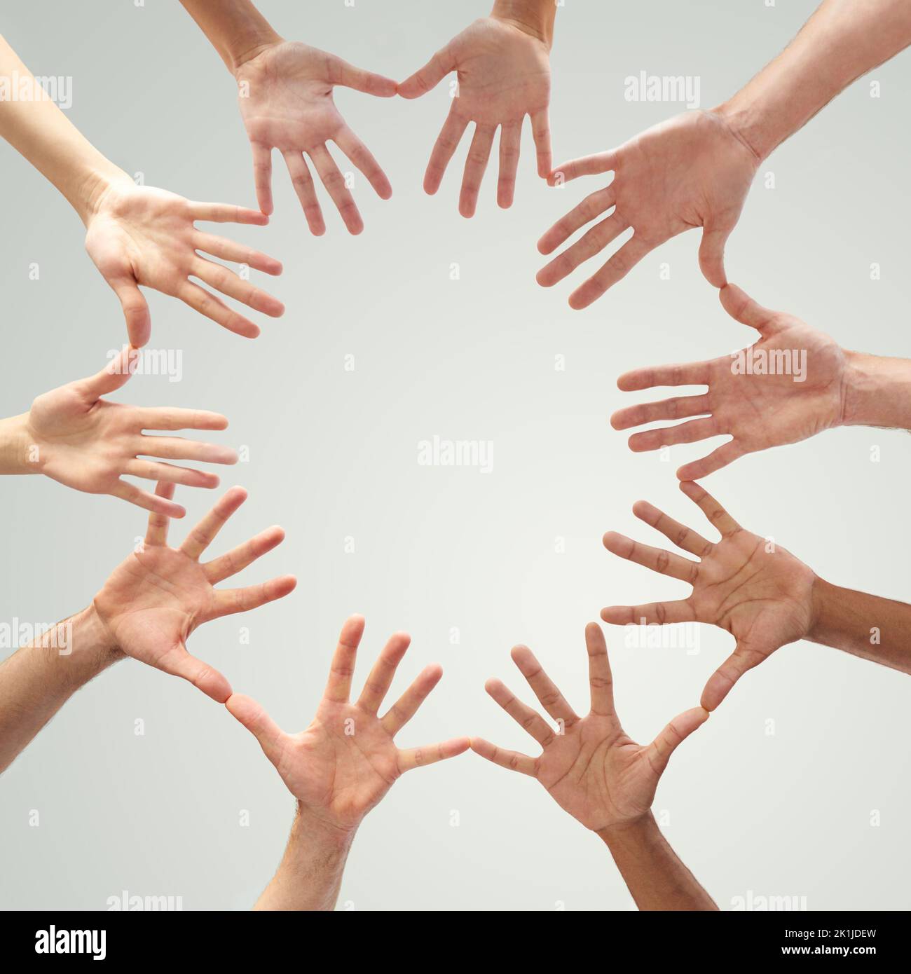 We support each other. Low angle shot of hands in a circle forming a ...