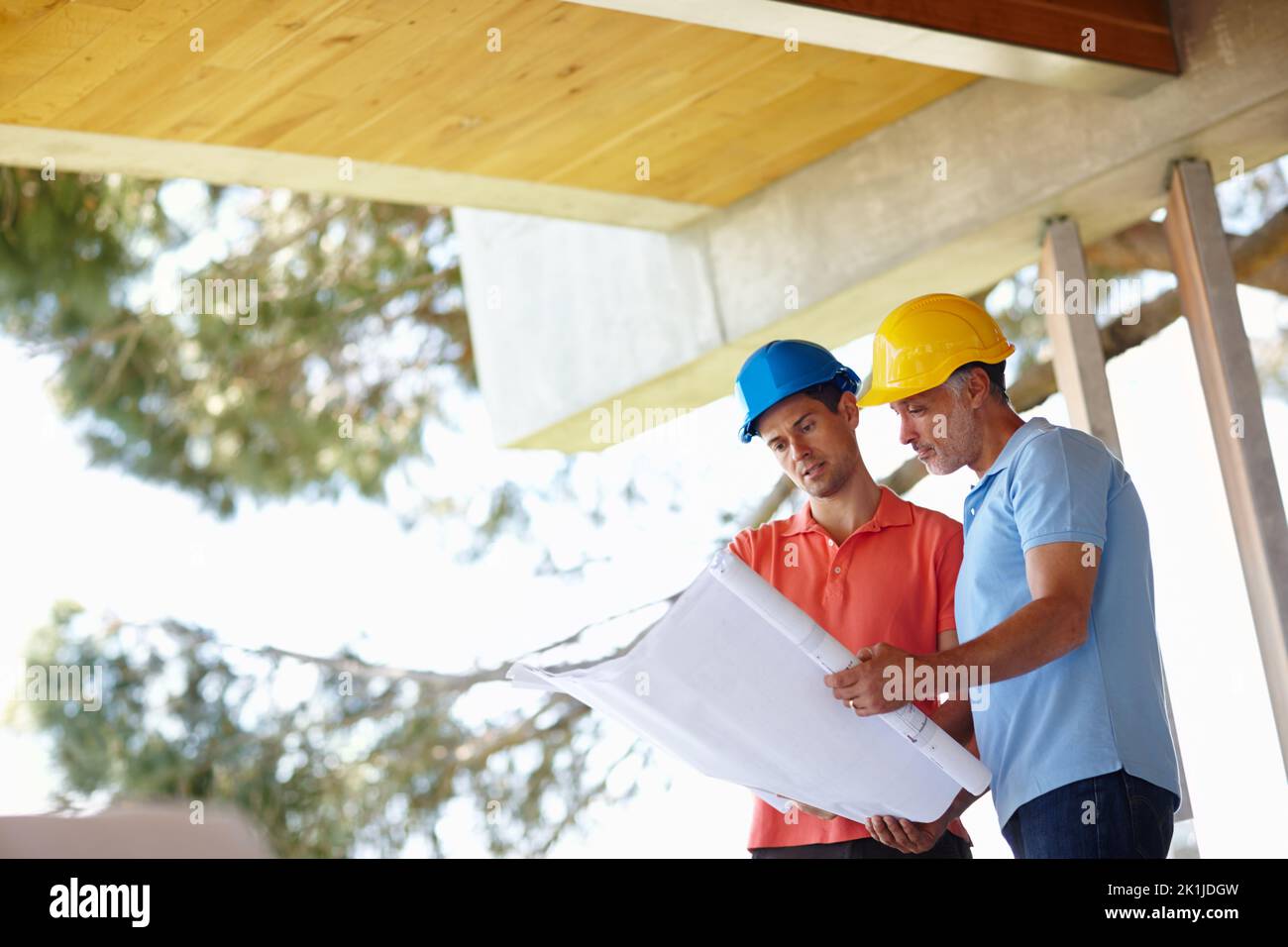 They gave these plans there all. Two men standing outdoors reading ...