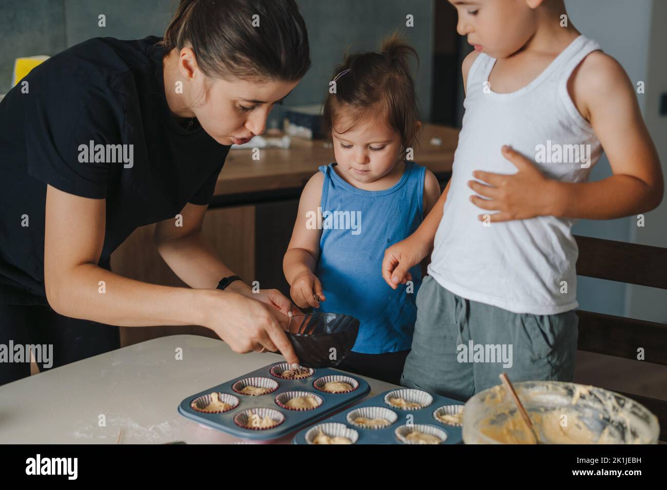 Preschooler son with little baby, baking homemade muffins, decorating ...