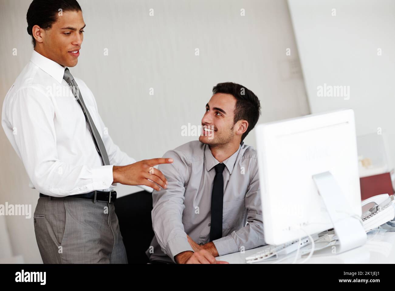 Giving a coworker some valued advice. A helpful businessman aiding a ...