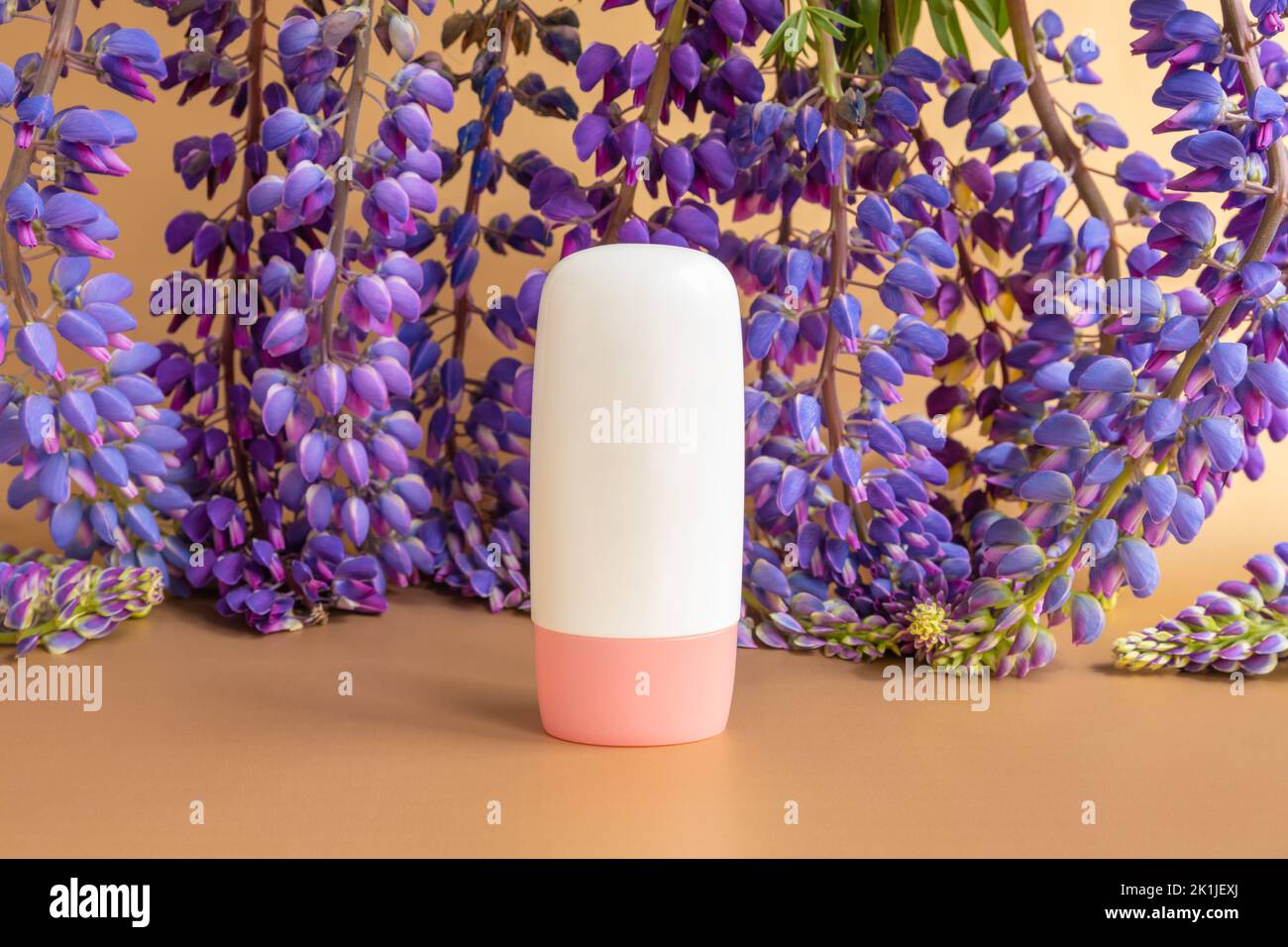 Mockup white tube bottle with pink screw cap for skin care cosmetic ...