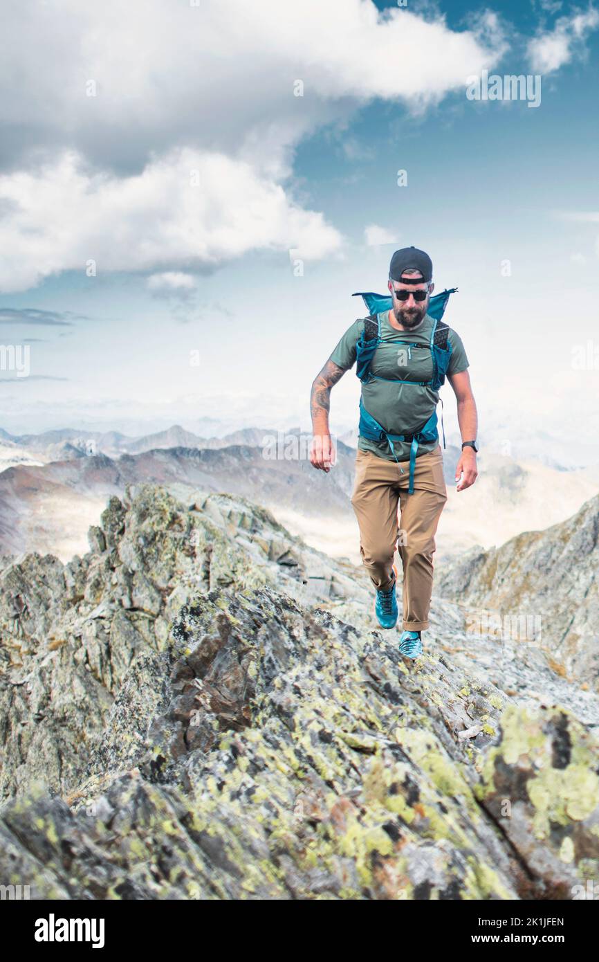 Man on alpine ridges in the mountains of northern Italy Stock Photo - Alamy