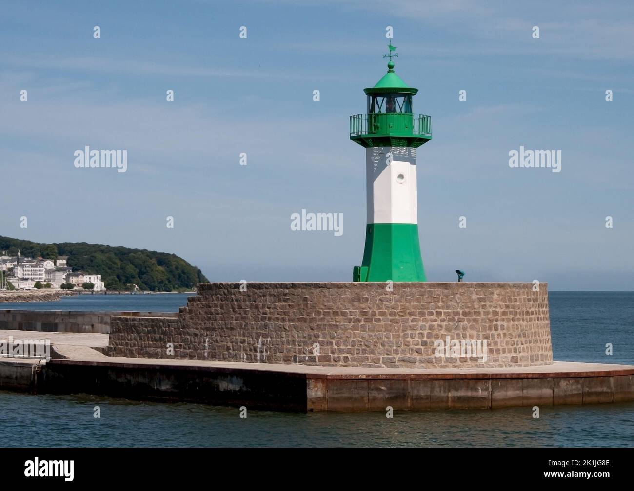 A scenic view of a white and green lighthouse on the beach Stock Photo ...