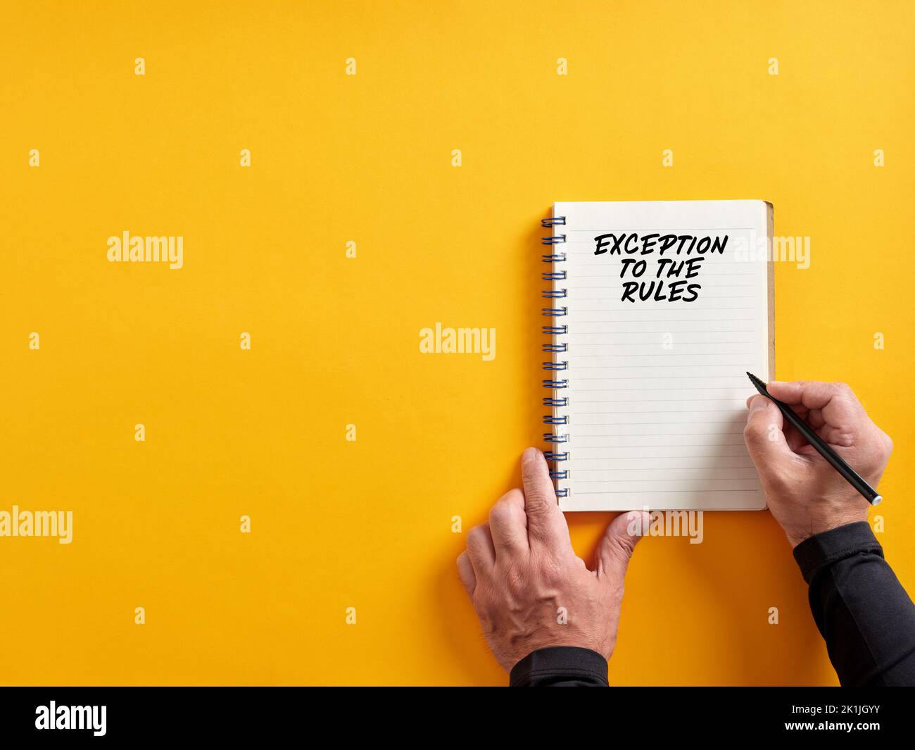 Male hand writing exception to the rules on a notepad. Exclusion from ...
