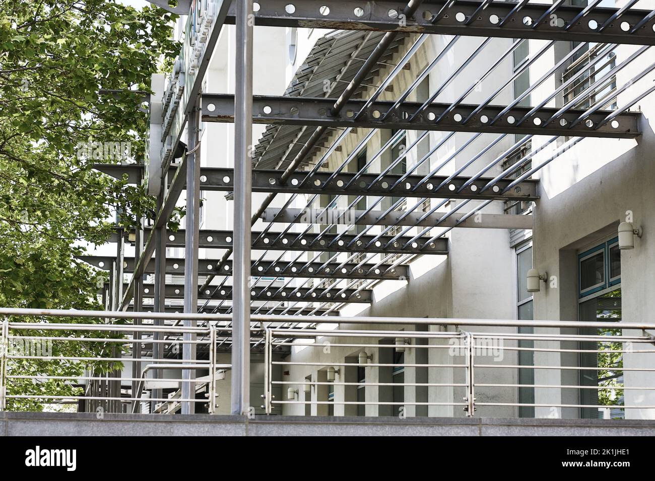 A view of a metallic construction against a building Stock Photo - Alamy