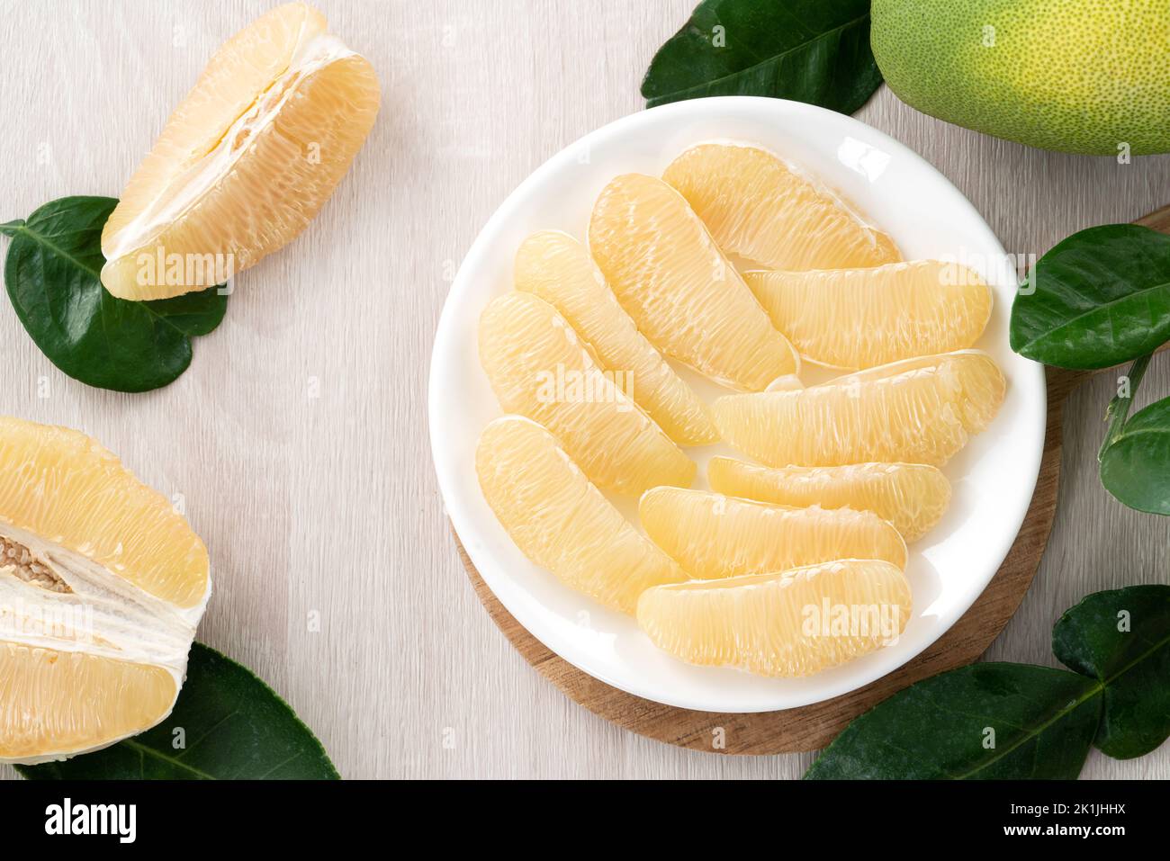 Top view of fresh peeled pomelo on bright wooden table background for ...