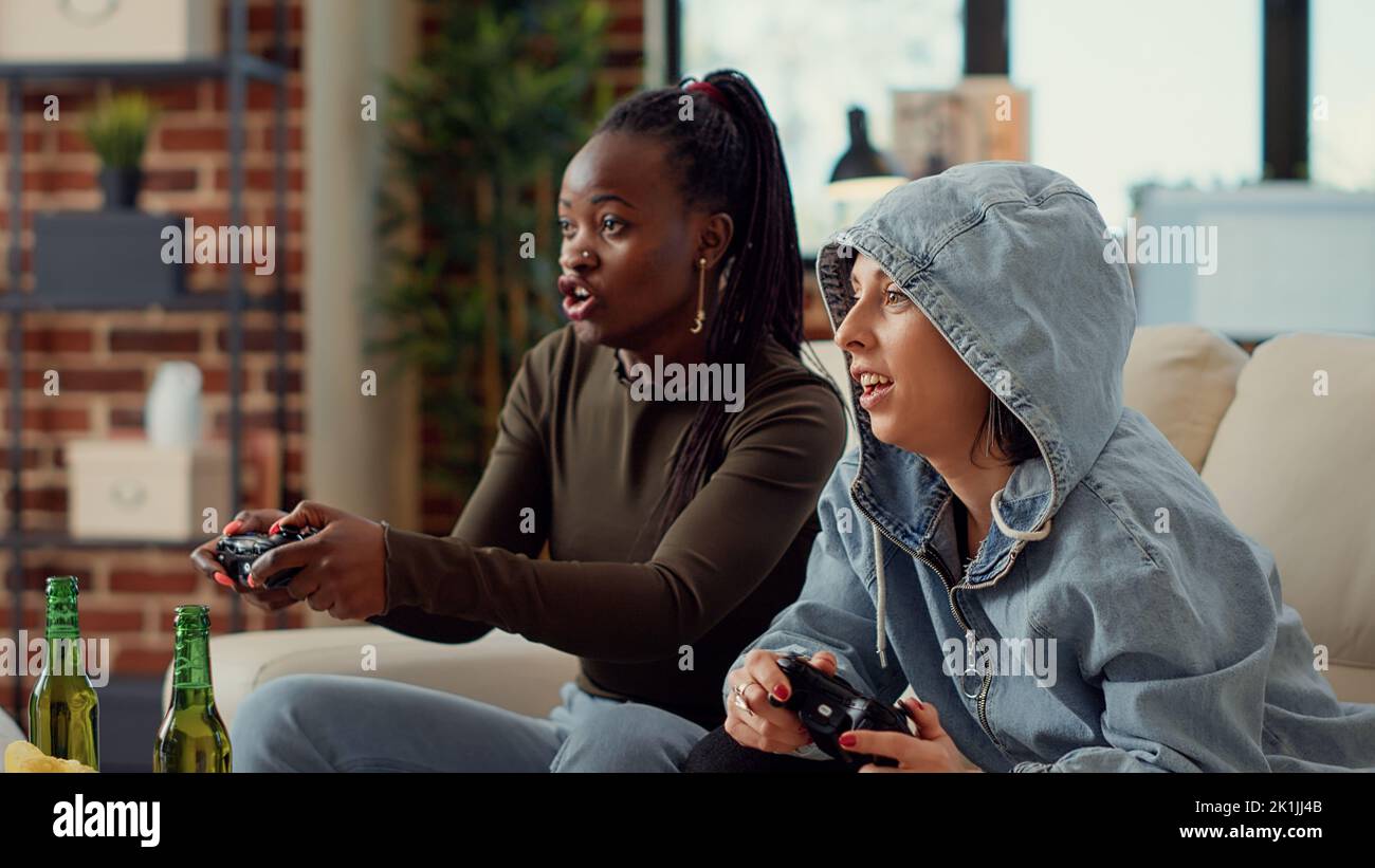 Multiethnic team of women playing video games online on television ...