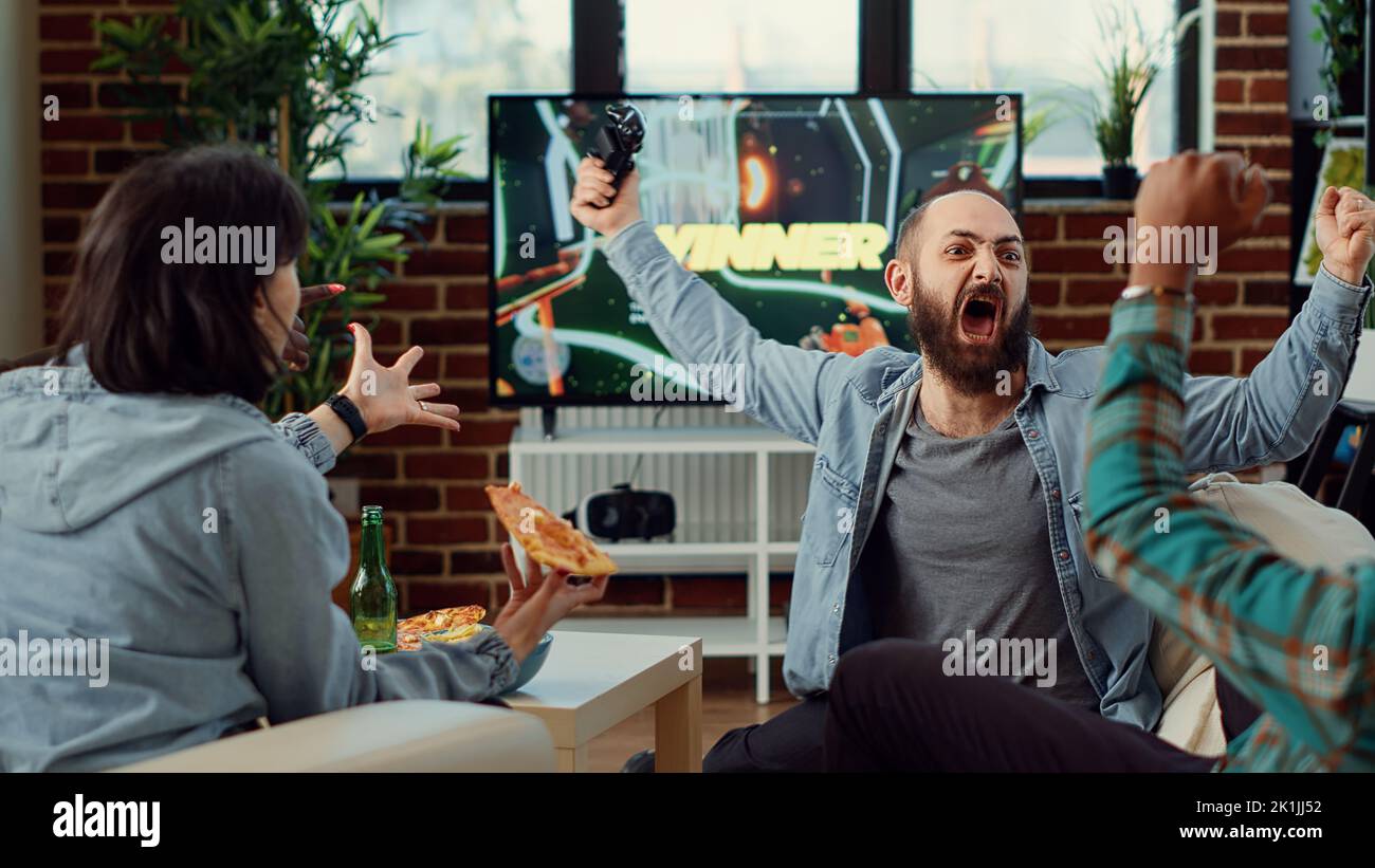 Group of friends feeling happy about winning gaming competition ...