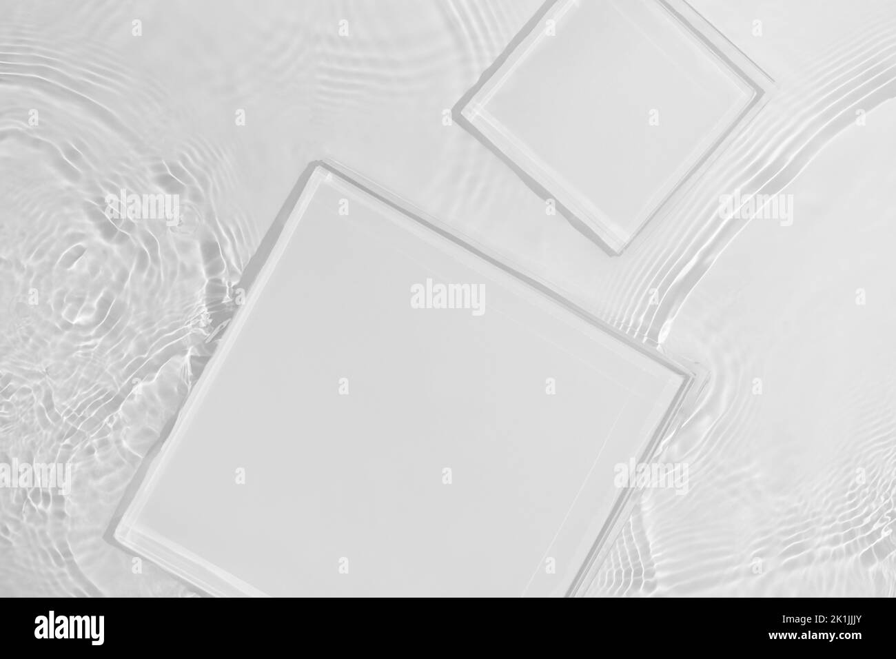 Two empty clear square podiums on transparent water background Stock ...