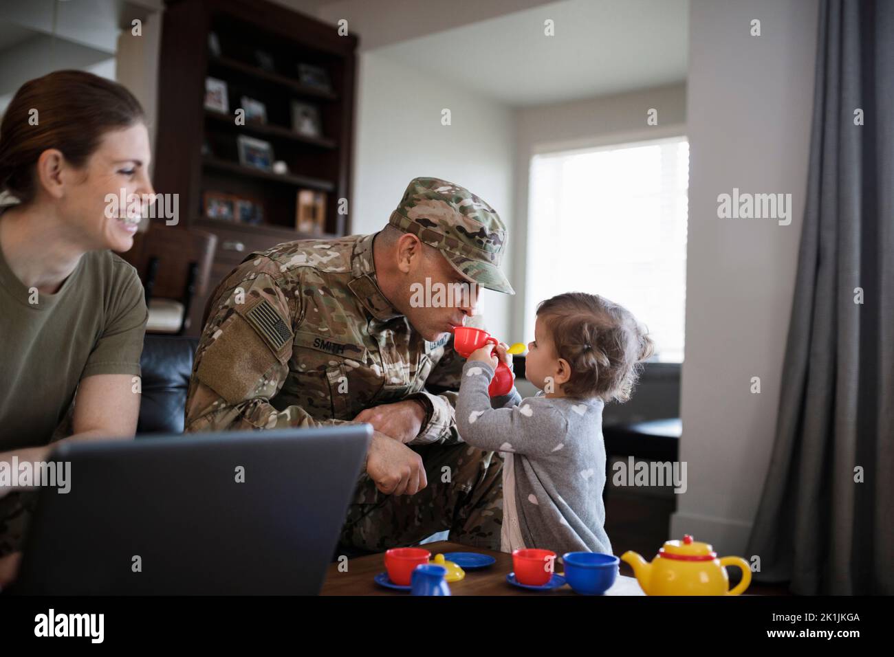 Soldier father playing tea party with preschool daughter Stock Photo ...