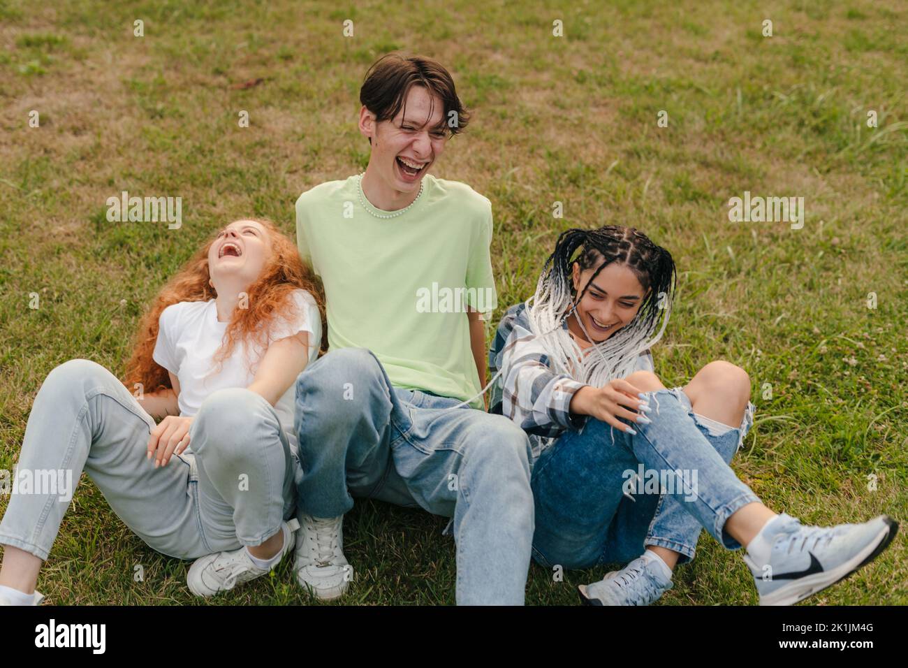 Happy young three best friends having fun together outdoors sitting on ...