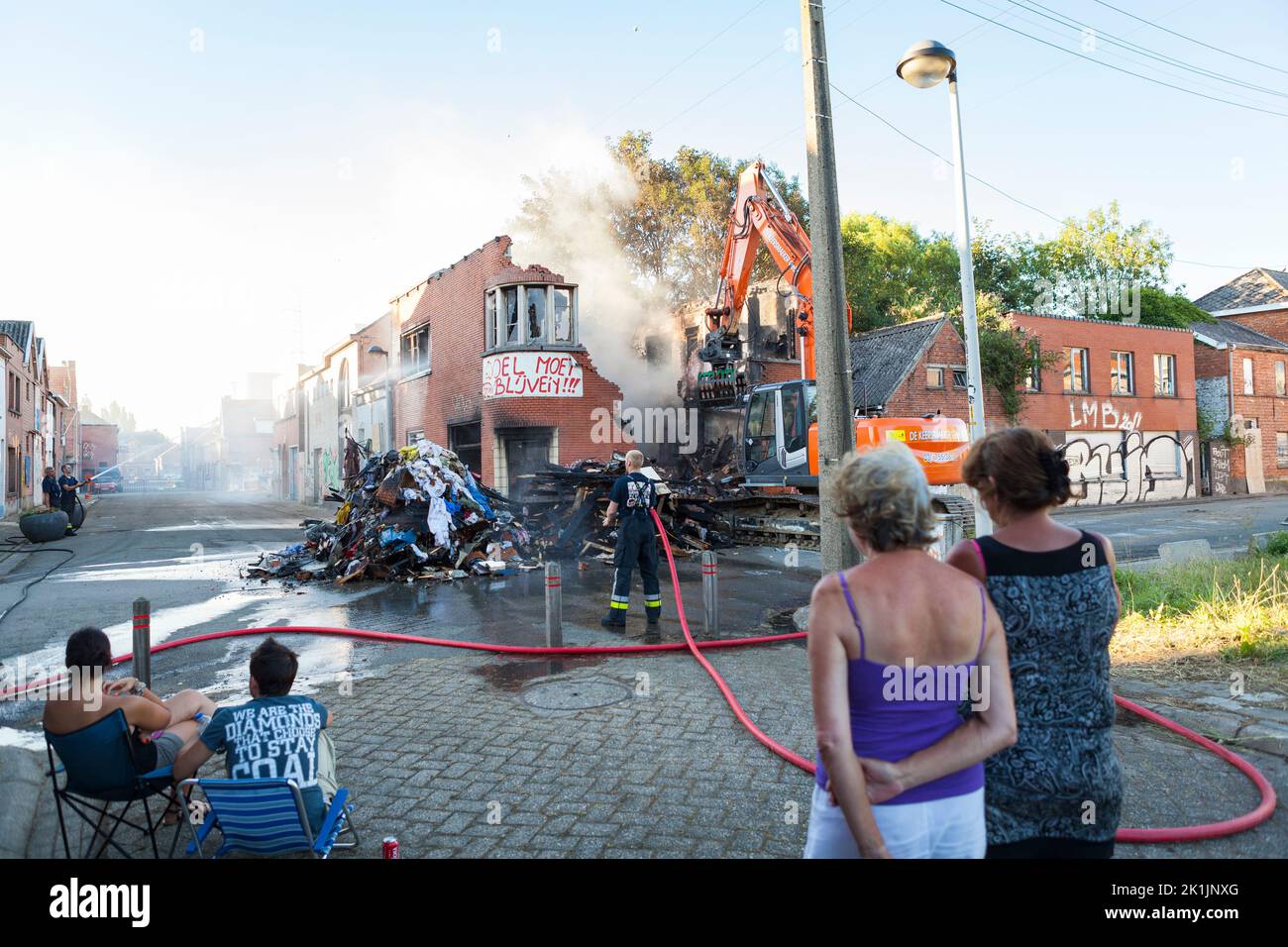 People watching the fire department extinguishing a fire at the ...