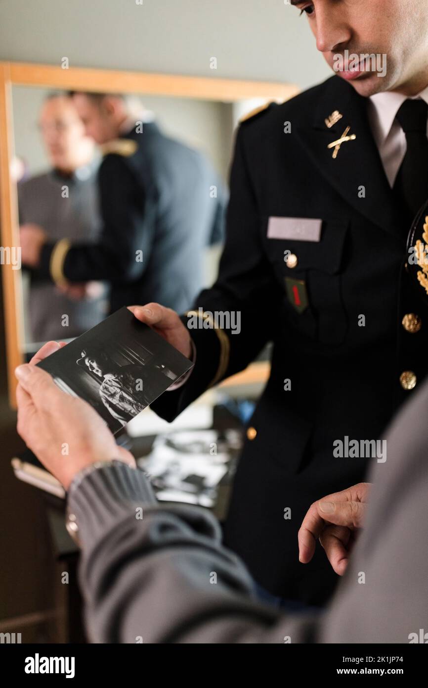 Military father and son looking at old photographs Stock Photo - Alamy