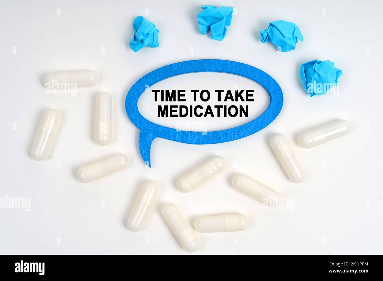 Medicine concept. On a white background pills, crumpled blue pieces of ...