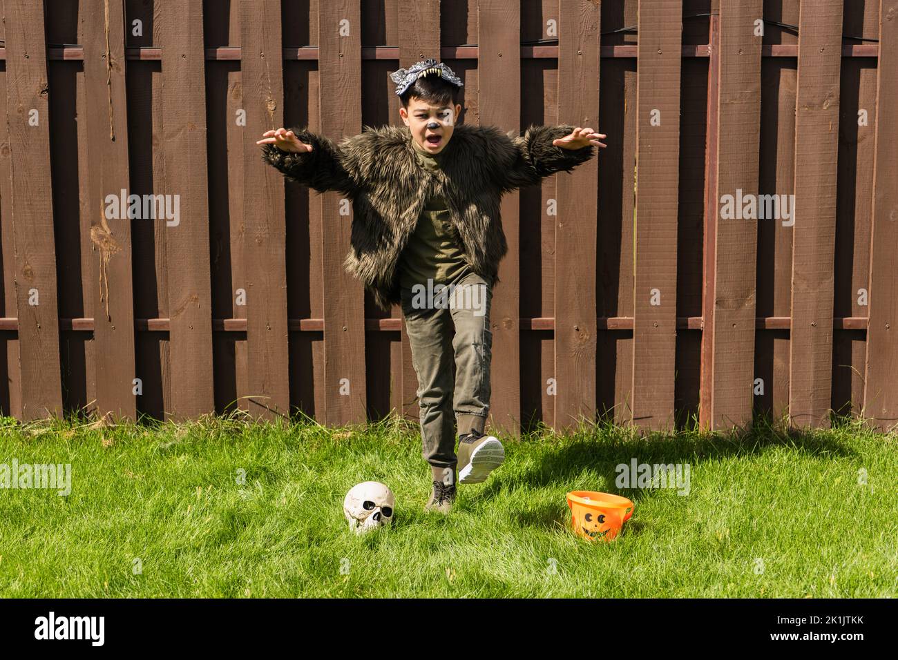 asian boy in werewolf costume growling and showing scary gesture near ...