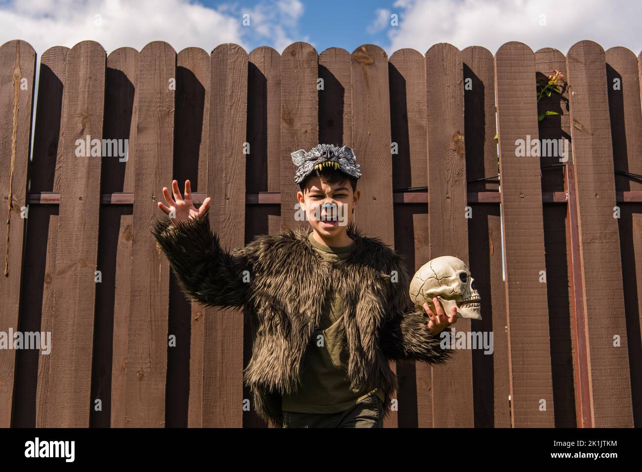 asian boy in werewolf costume showing frightening grimace and gesturing ...