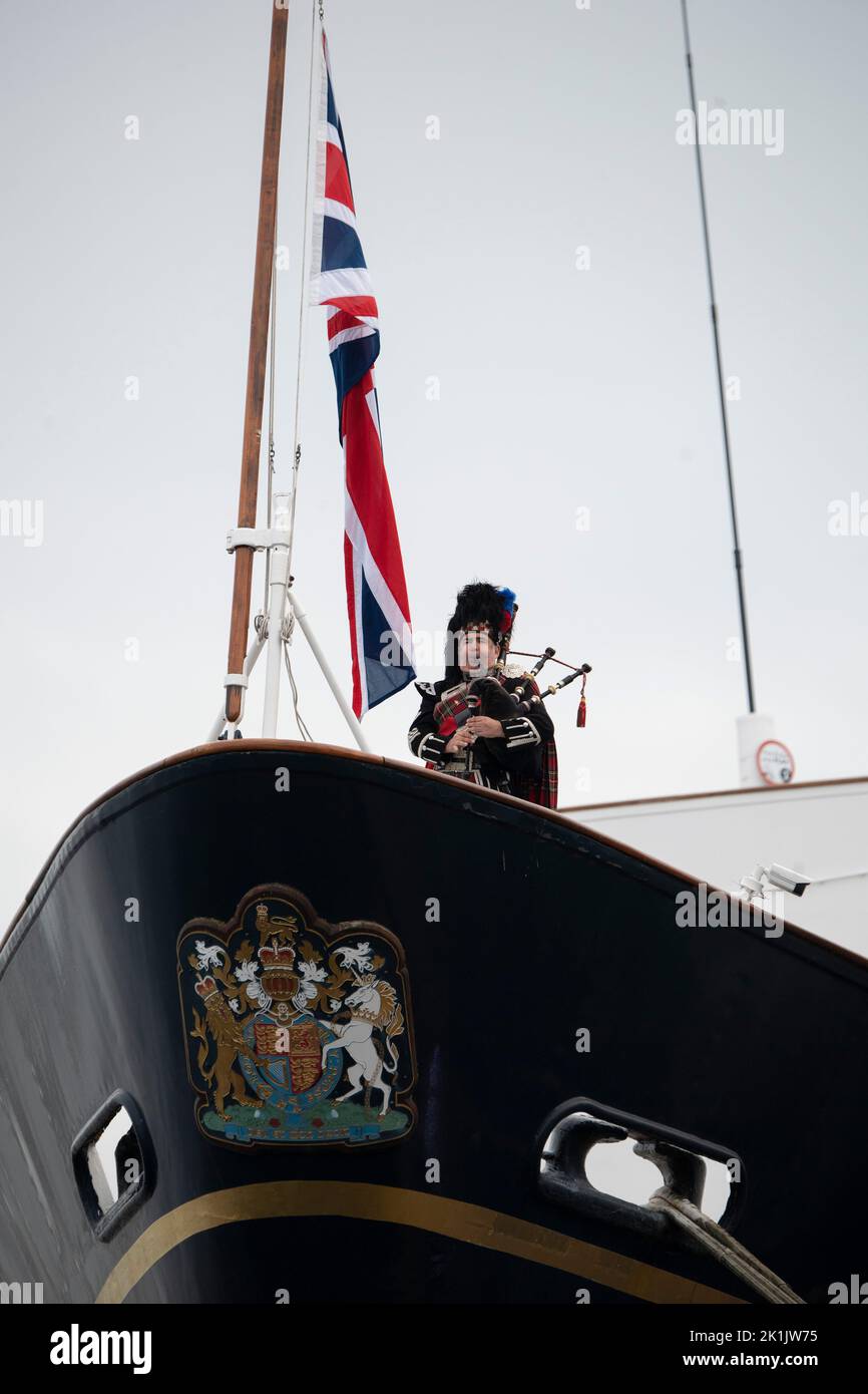 A piper plays a lament piper aboard the Royal Yacht Britannia, moored ...