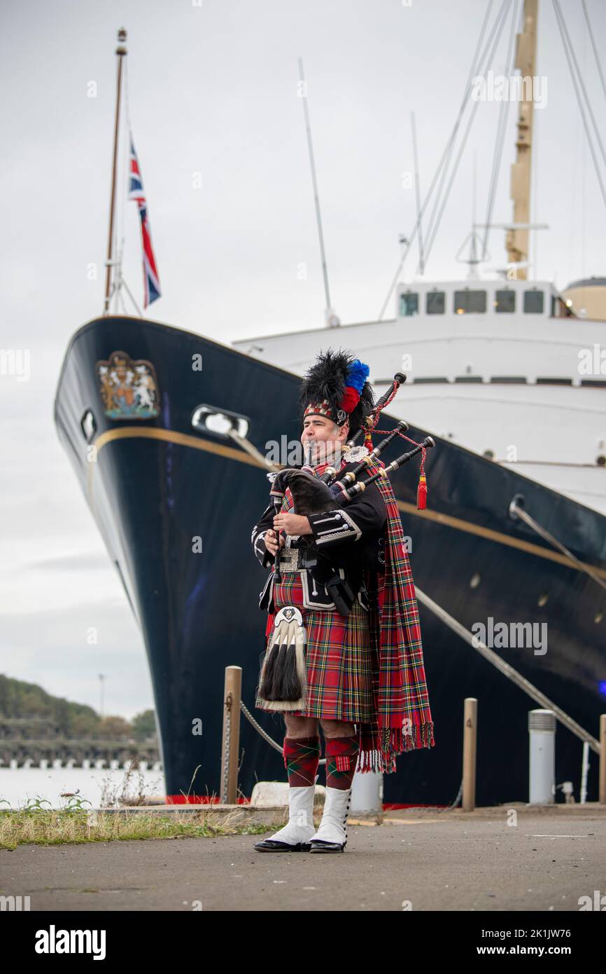 A piper plays a lament piper aboard the Royal Yacht Britannia, moored ...