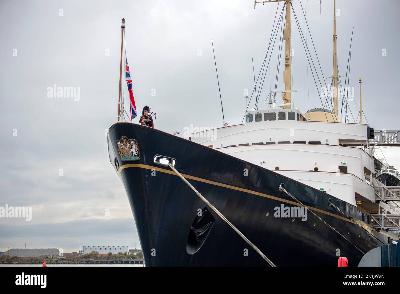 A piper plays a lament piper aboard the Royal Yacht Britannia, moored ...
