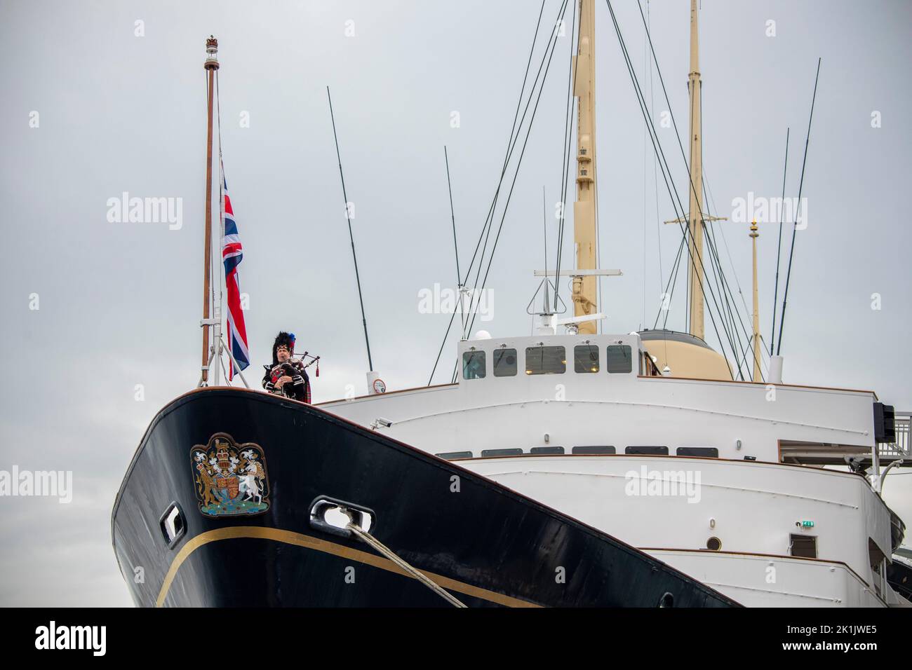 A piper plays a lament piper aboard the Royal Yacht Britannia, moored ...