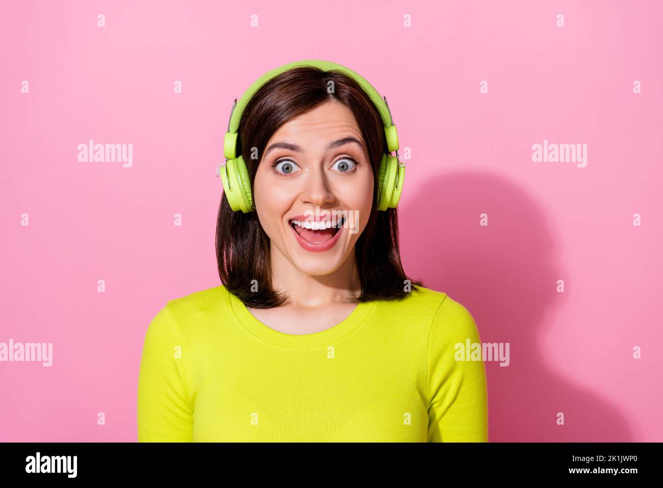 Photo of astonished positive lady listen music open mouth unbelievable ...