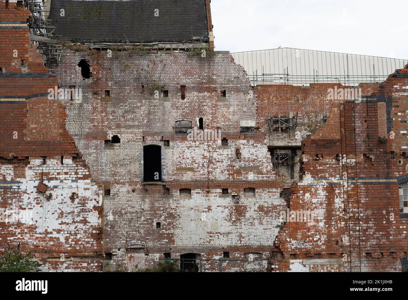An old red brick abandoned building facade Stock Photo - Alamy