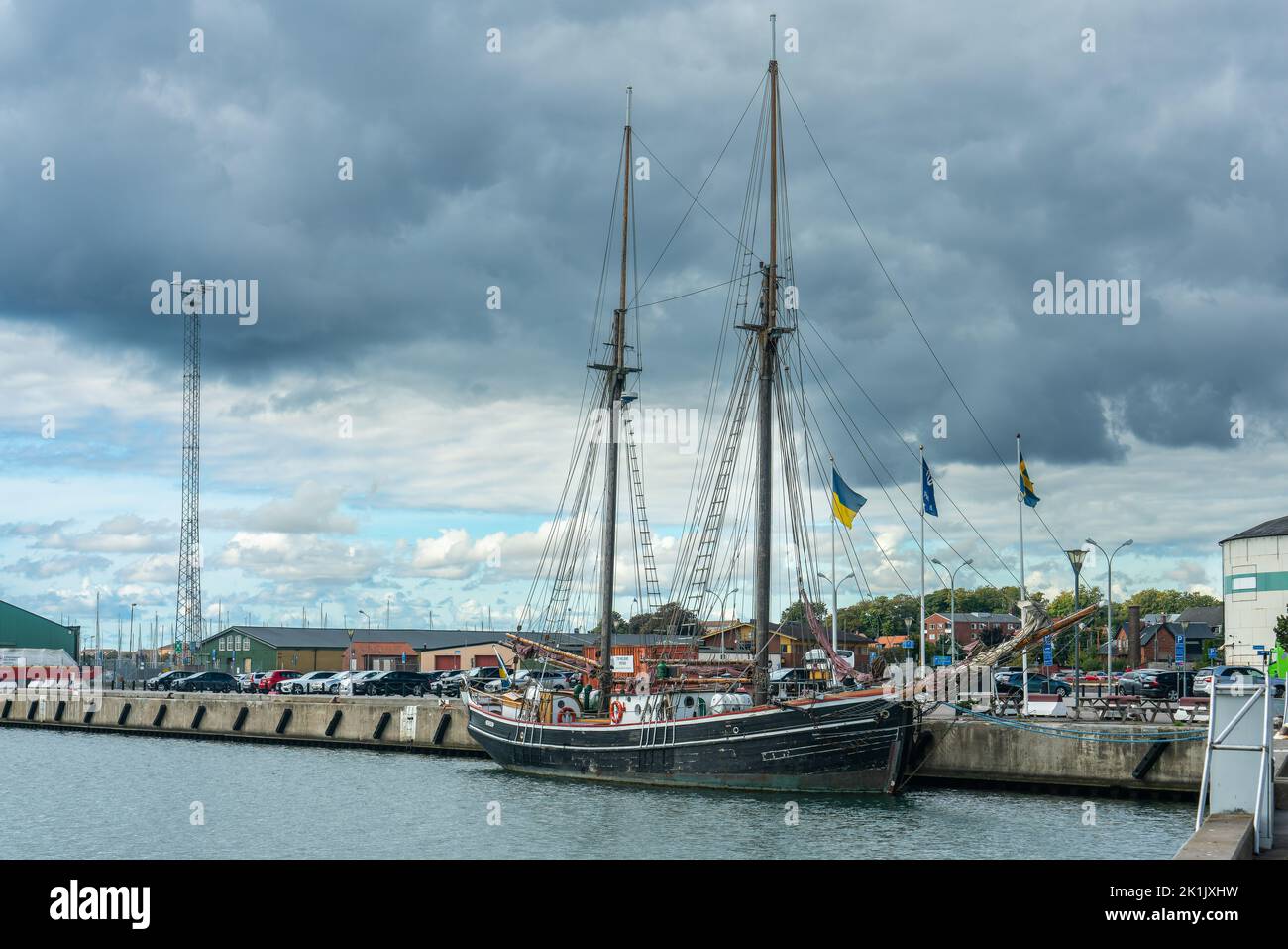 A large two masted sailing ship docking in the harbor of Ystad under ...