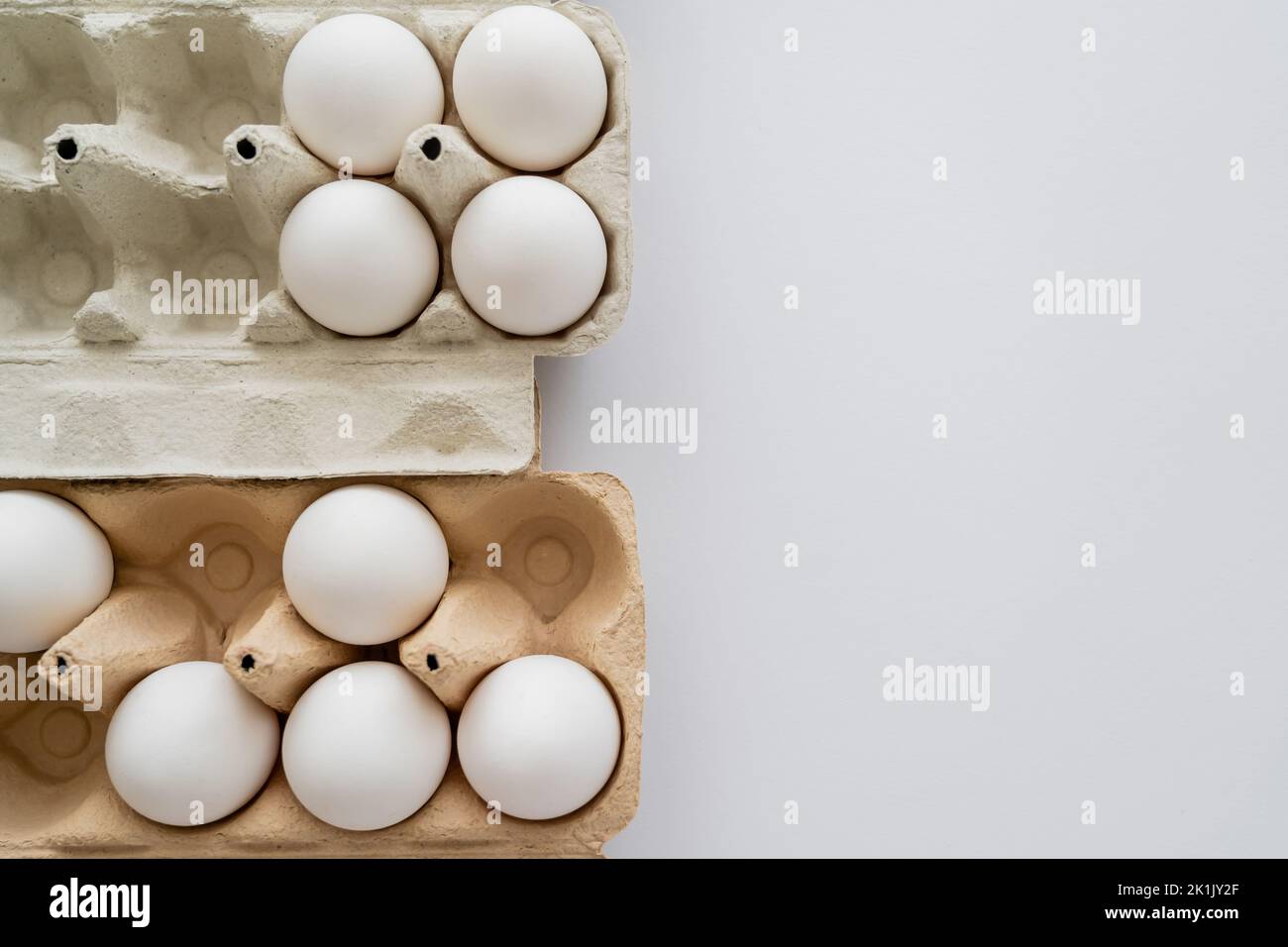 Top view of chicken eggs in trays on white background Stock Photo - Alamy