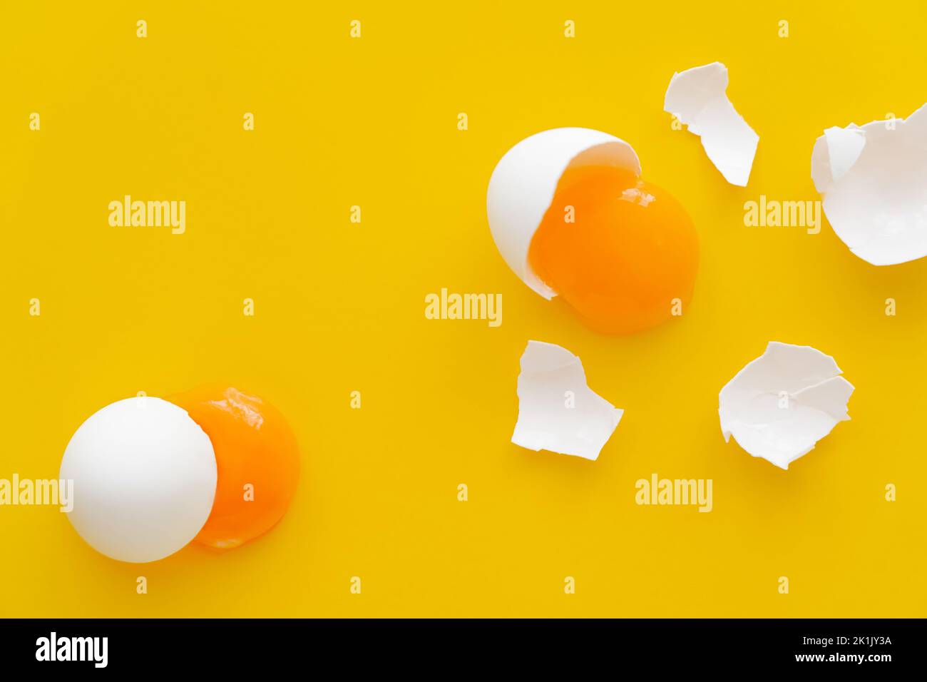 Top view of yolks and white egg shells on yellow background Stock Photo ...