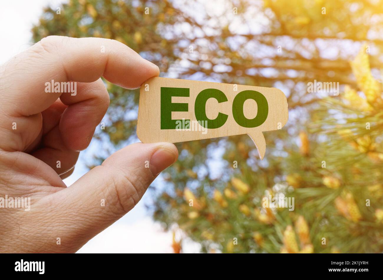 Ecology concept. A man holds a sign inside which the inscription - ECO ...