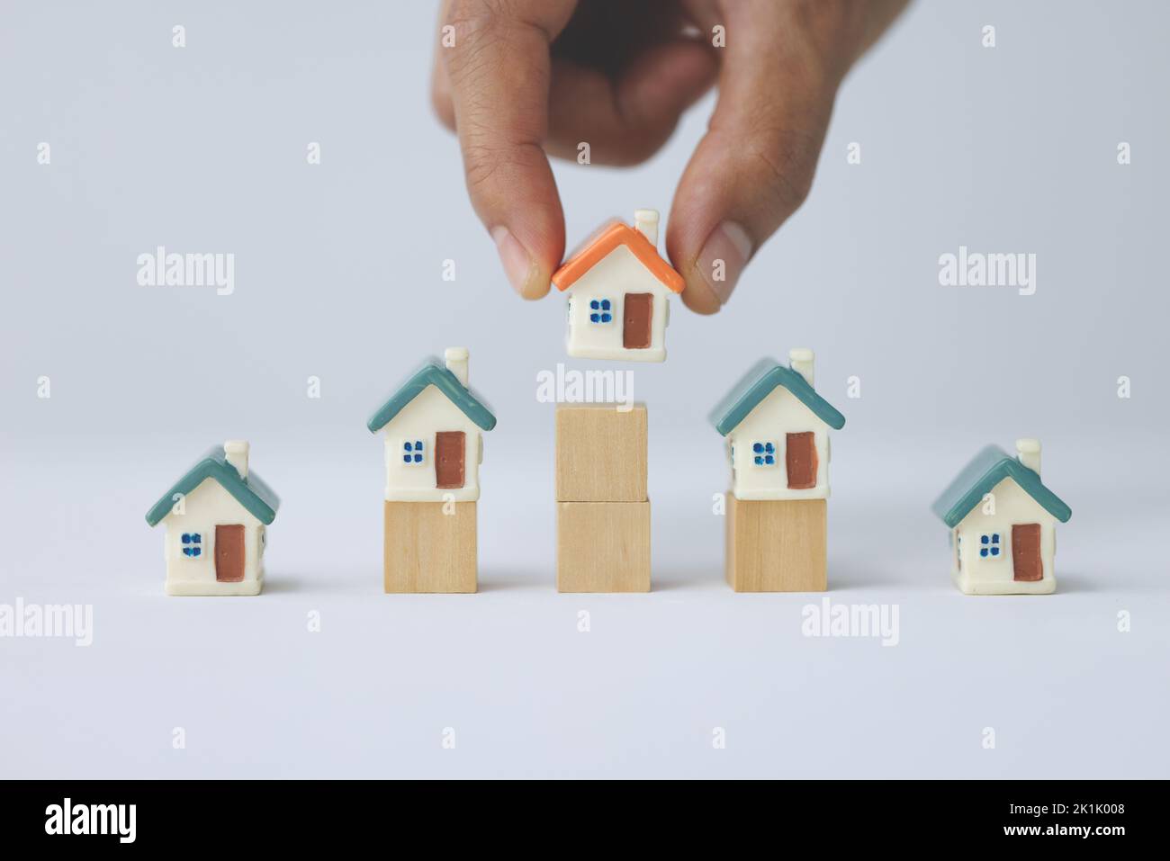 Real estate investors hold home models in hands. Saving plan to buy ...