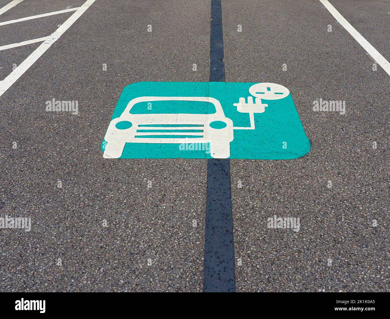 An electric charging sign on the asphalt road under the sunlight Stock ...