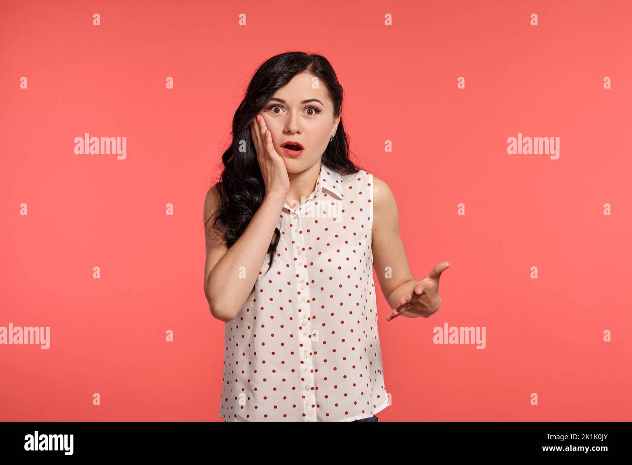 Studio shot of a beautiful girl teenager posing over a pink background ...