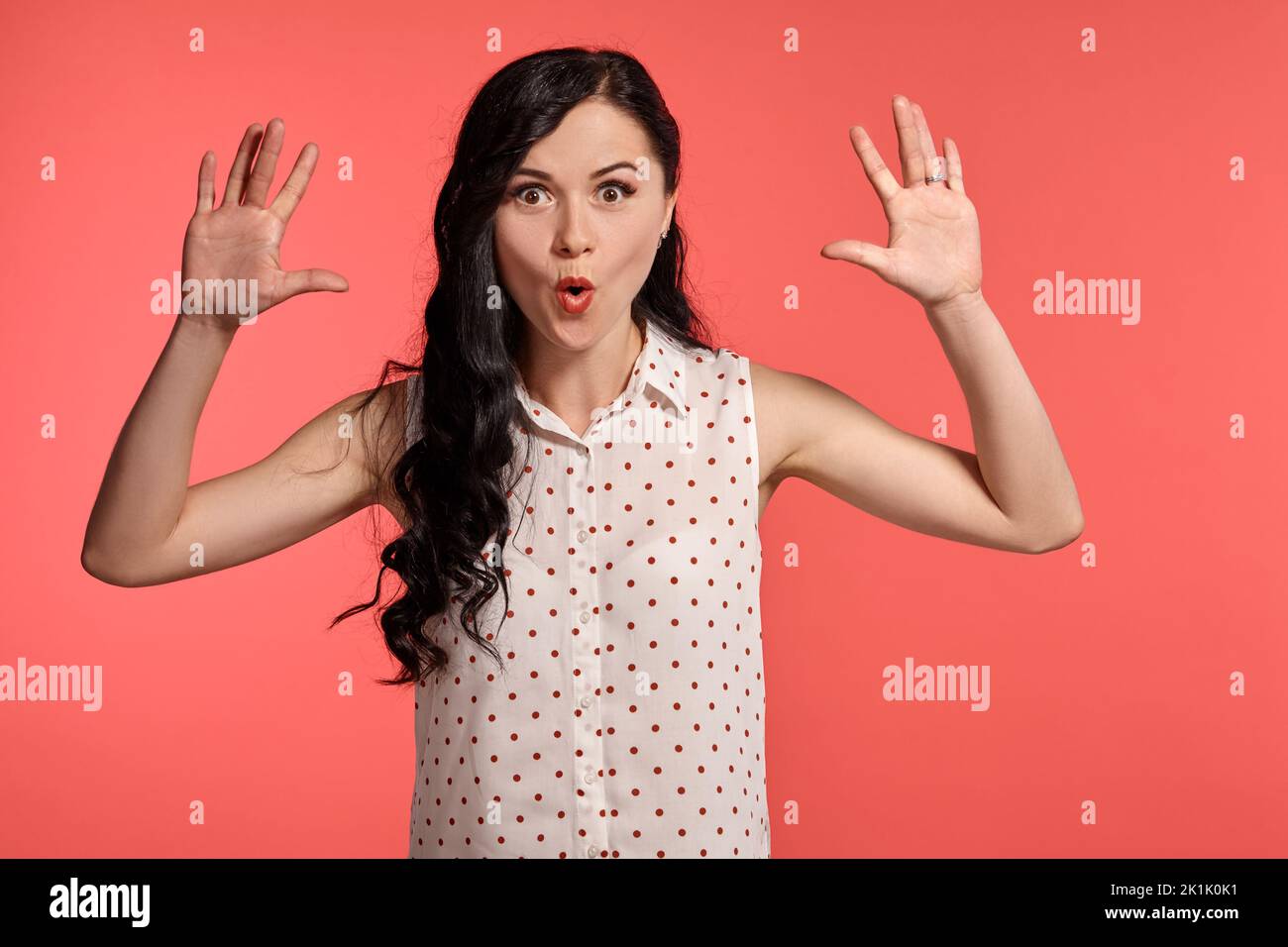 Studio shot of a beautiful girl teenager posing over a pink background ...