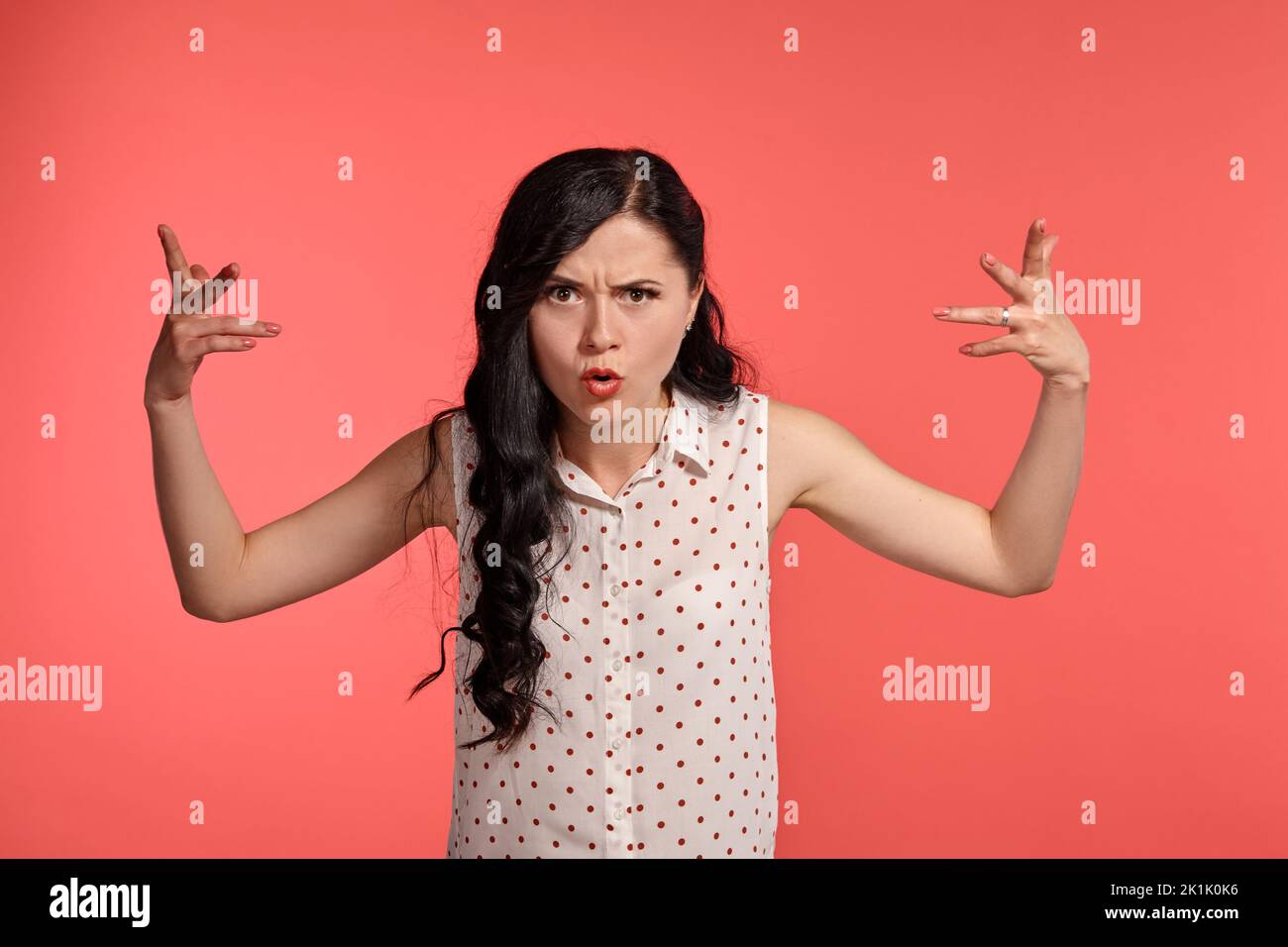 Studio shot of a beautiful girl teenager posing over a pink background ...