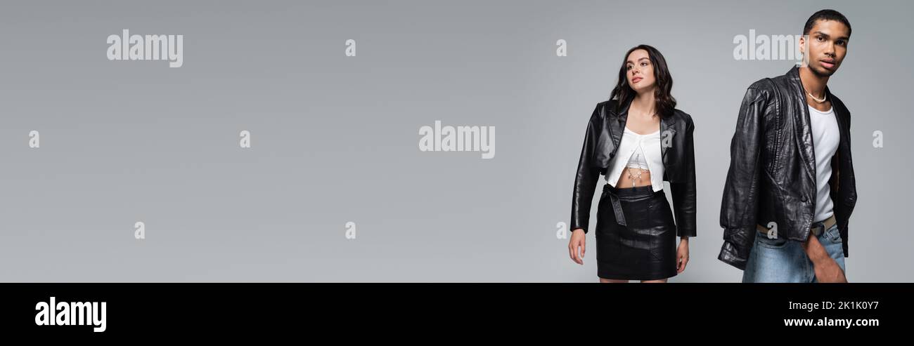 young interracial couple in stylish autumnal outfits posing isolated on ...