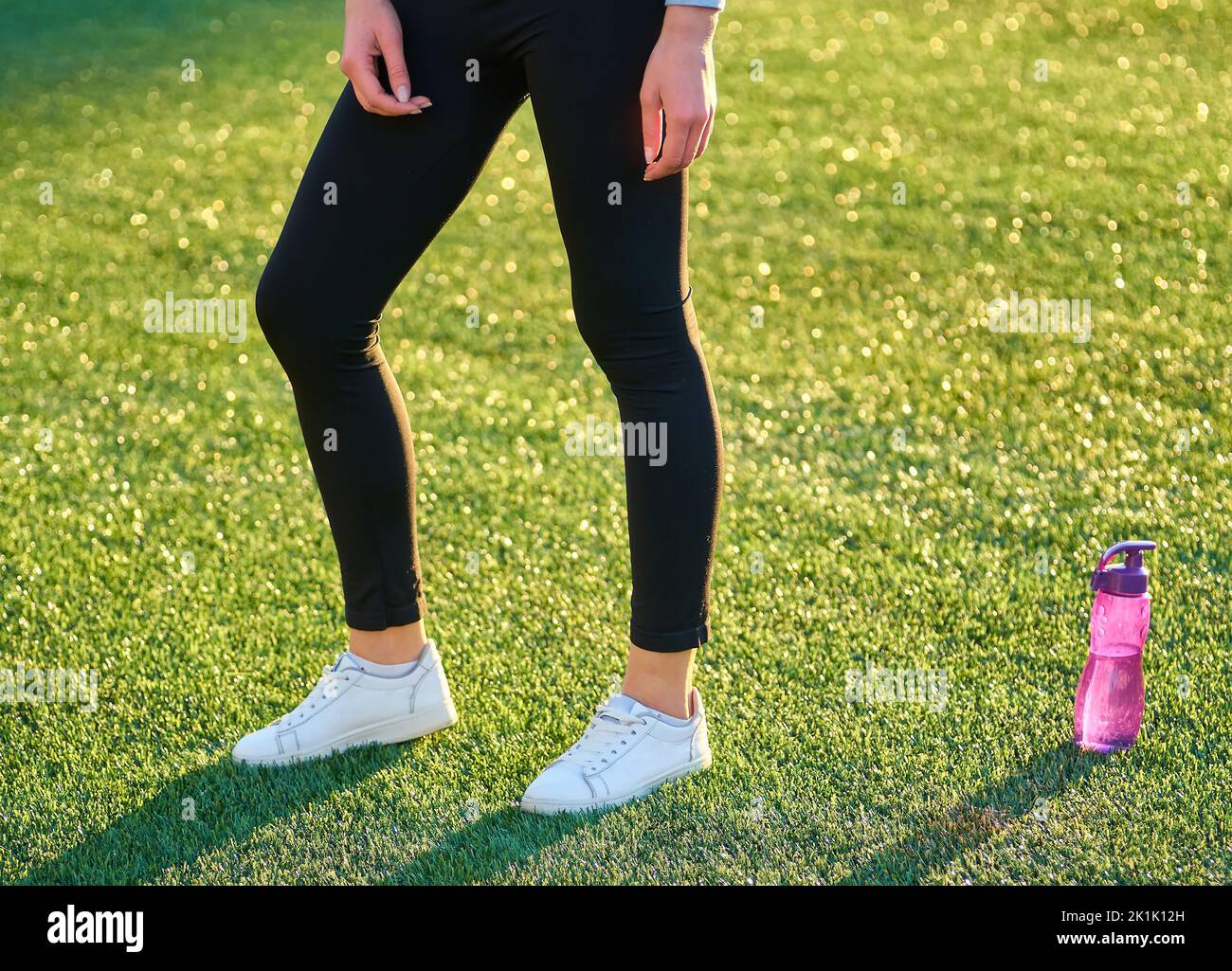 Sports girl doing stretching on the stadium lawn Stock Photo - Alamy