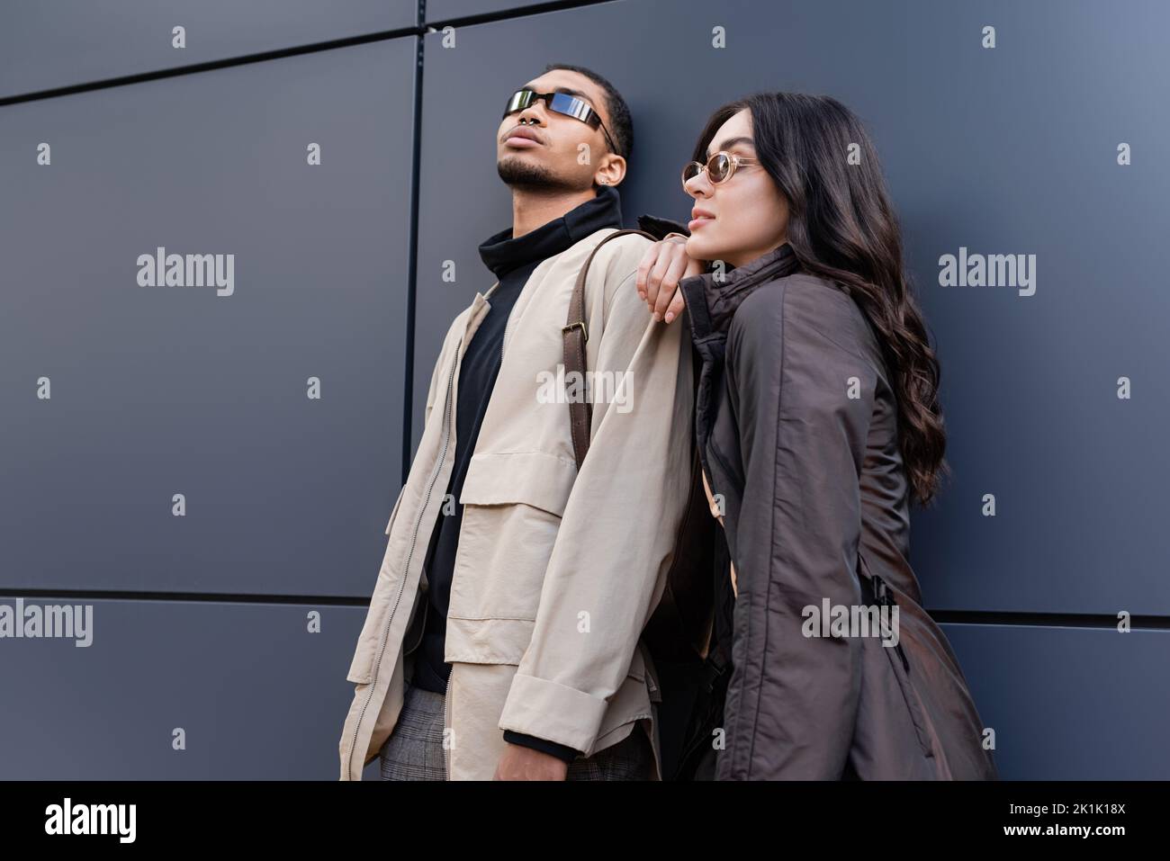 stylish interracial couple in autumnal outfits and trendy sunglasses ...