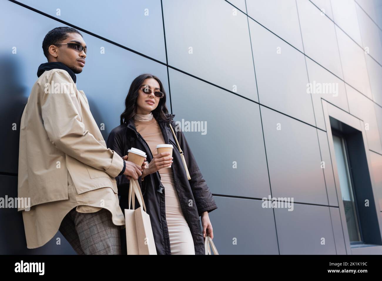 young african american man and brunette woman in stylish sunglasses ...