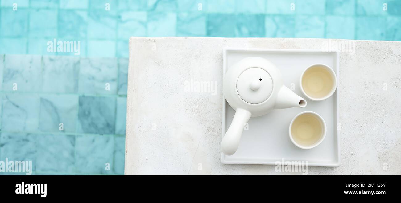 hot tea pot near swimming pool in luxury hotel. Summer travel, vacation ...