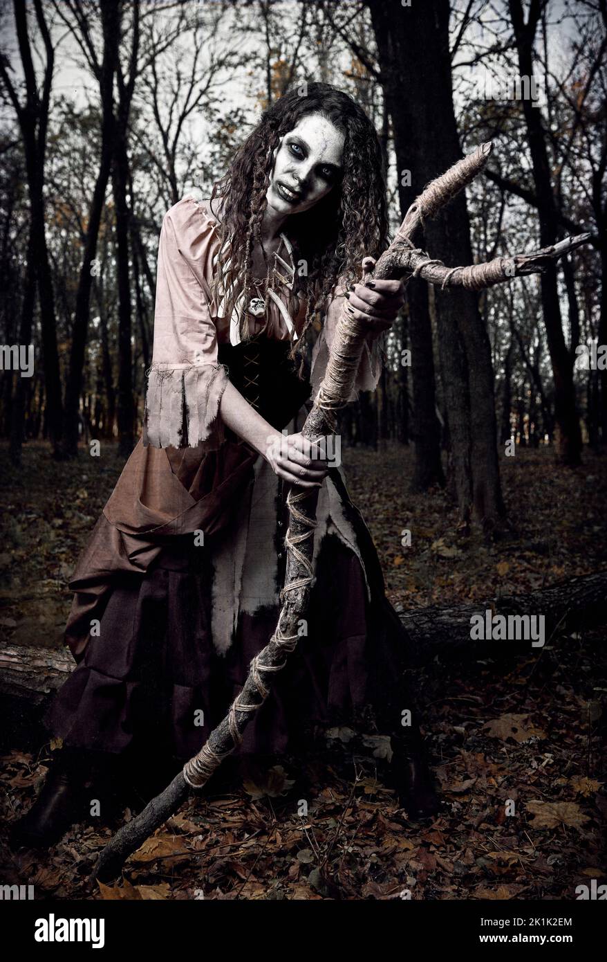Halloween (Samhain) theme: ugly fearful voodoo witch with staff ...