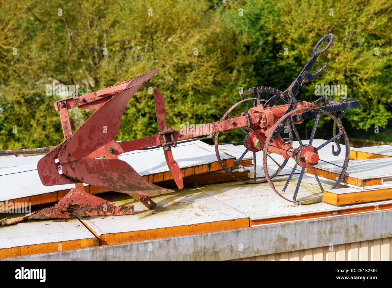 Vintage metal plow with wheels for tillage. Antique agricultural ...