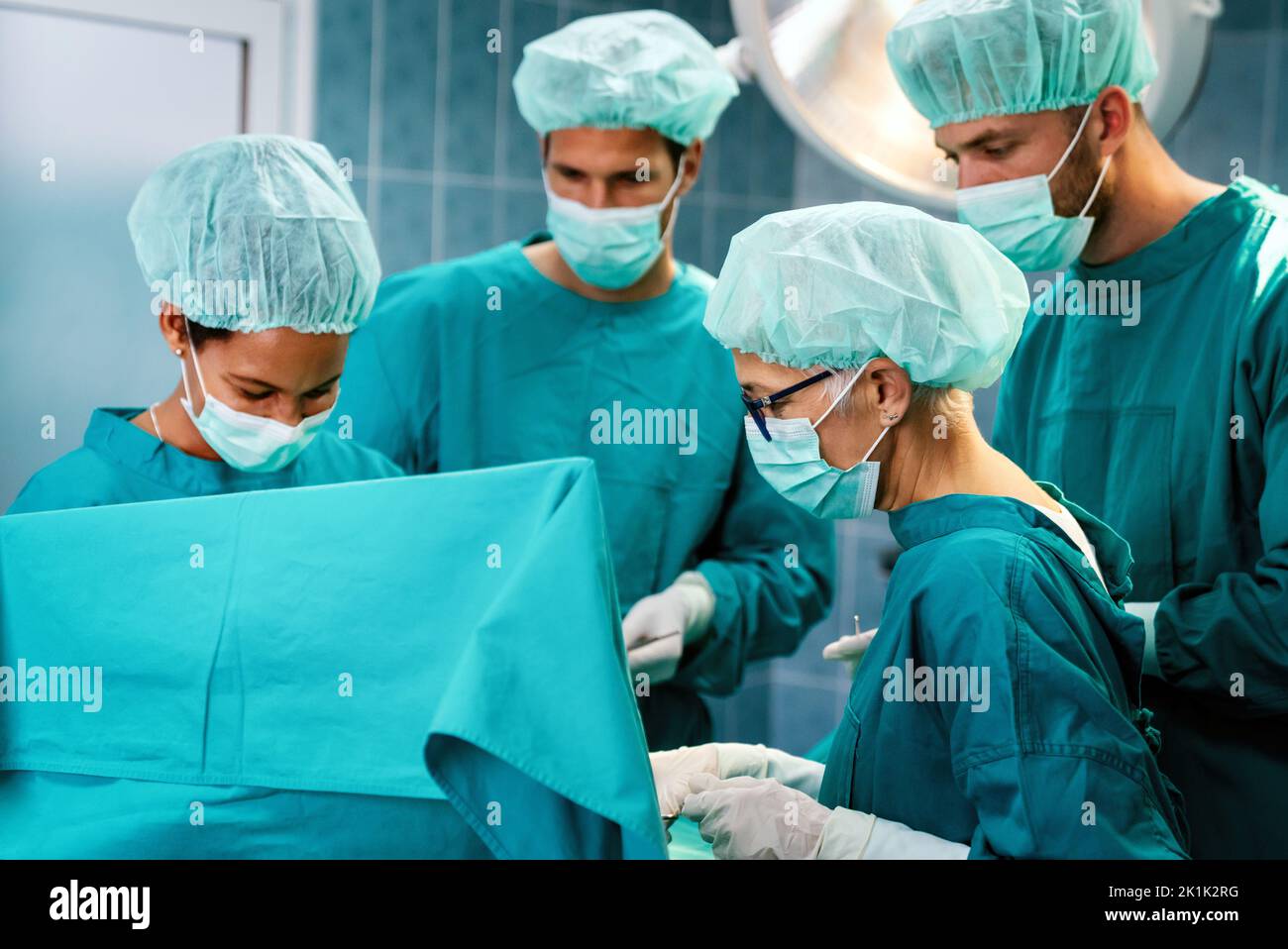 Surgery team operating in a surgical room Stock Photo - Alamy