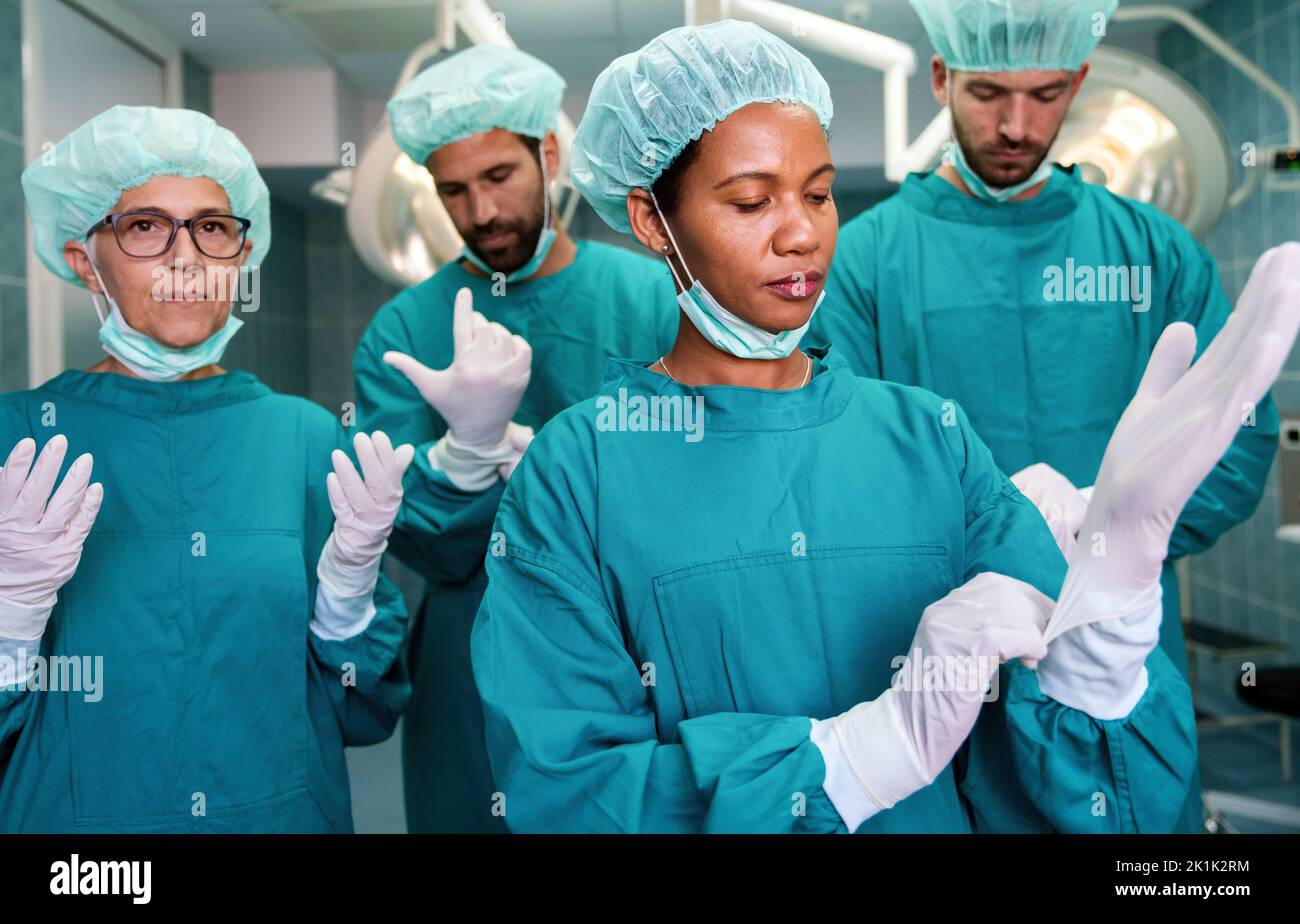 Successful team of surgeon standing in operating room, ready to work on ...